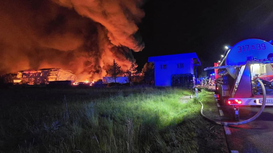 Firefighters battle through the night to contain huge fire at Polish ...